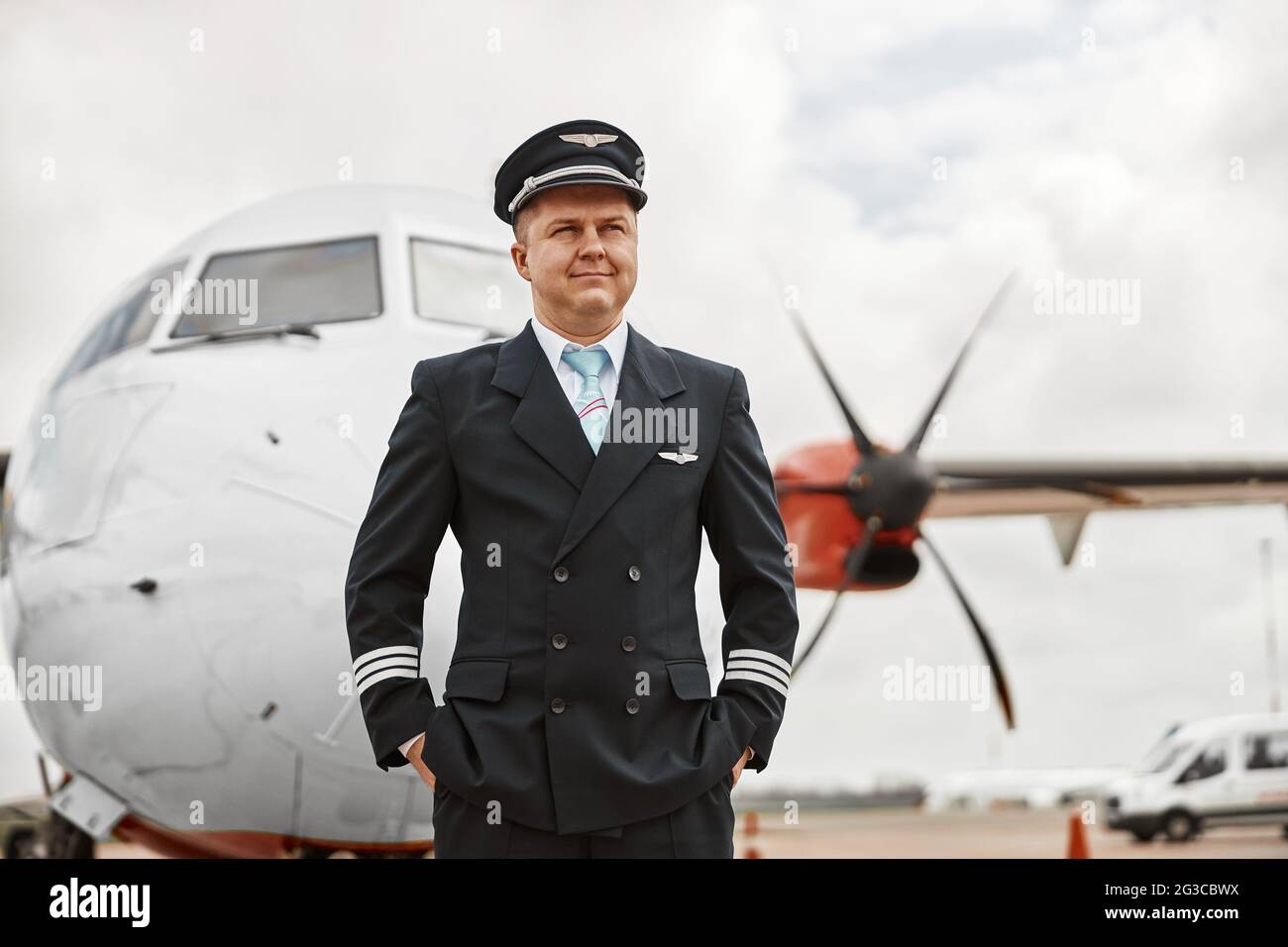 Pilot stand on runway on airplane jet background Stock Photo - Alamy