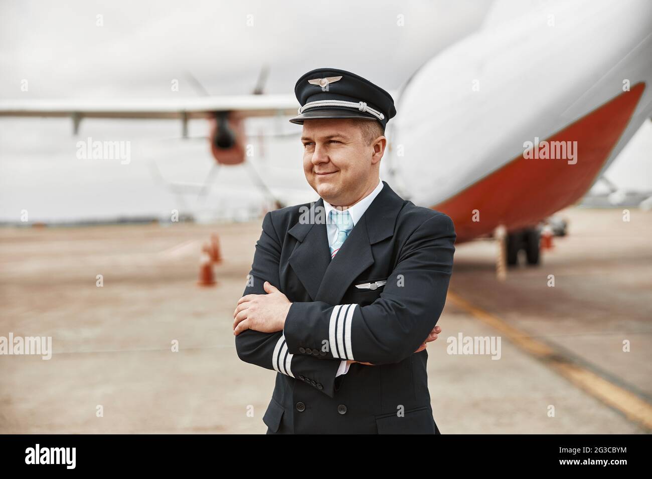 Pilot stand on runway on airplane jet background Stock Photo - Alamy