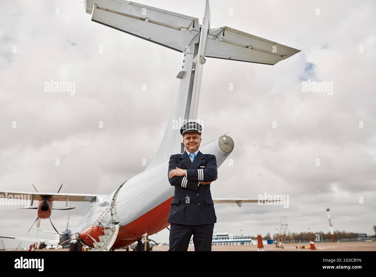 Pilot stand on runway on airplane jet background Stock Photo - Alamy