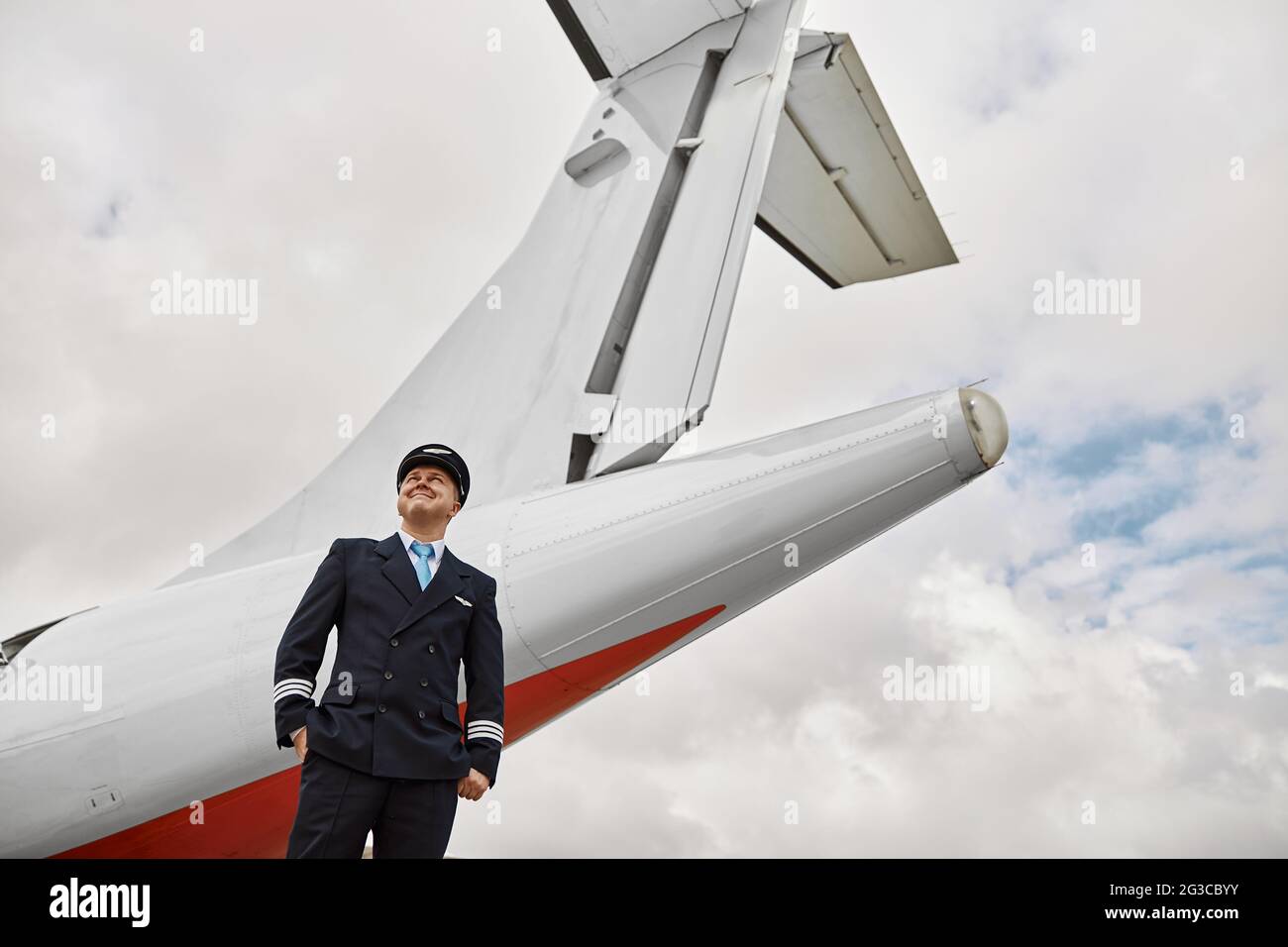Pilot stand on runway on airplane jet background Stock Photo - Alamy