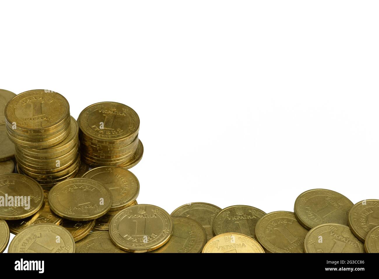 Scattered shiny yellow iron coins and in stacks on a white background ...