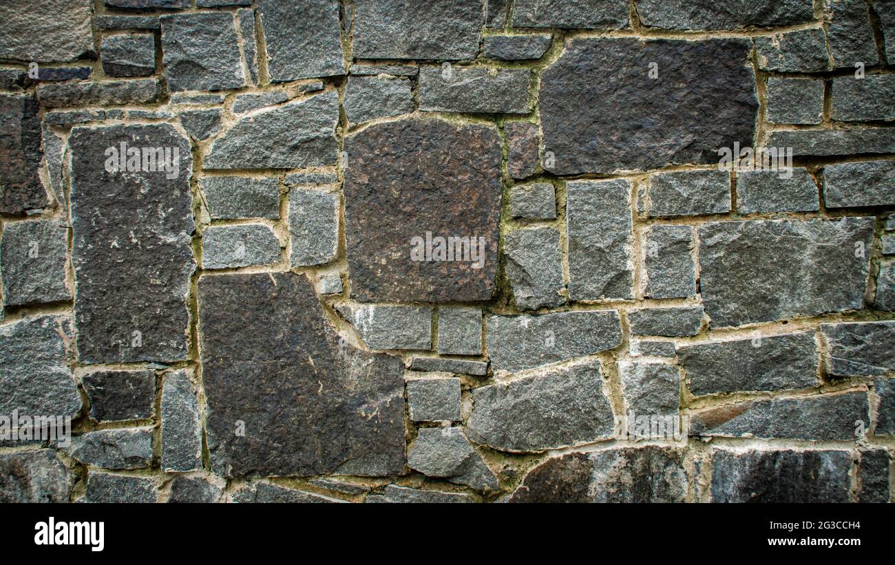 masonry of stones of different sizes in gray, background or texture ...
