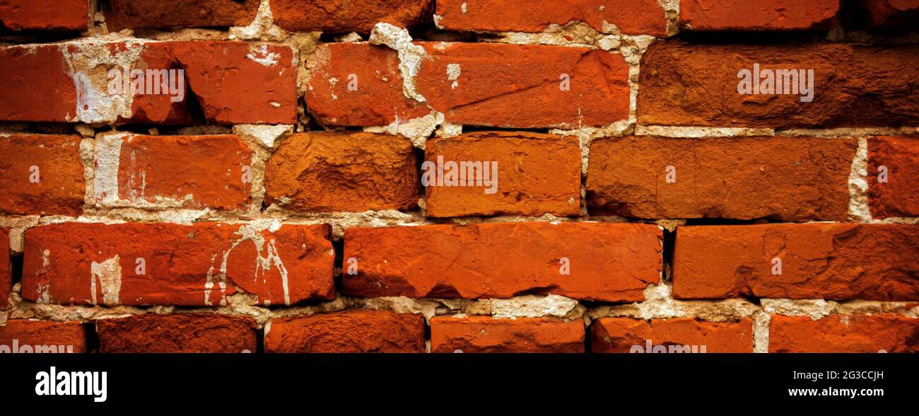 old wall of bright red brick with light seams Stock Photo - Alamy