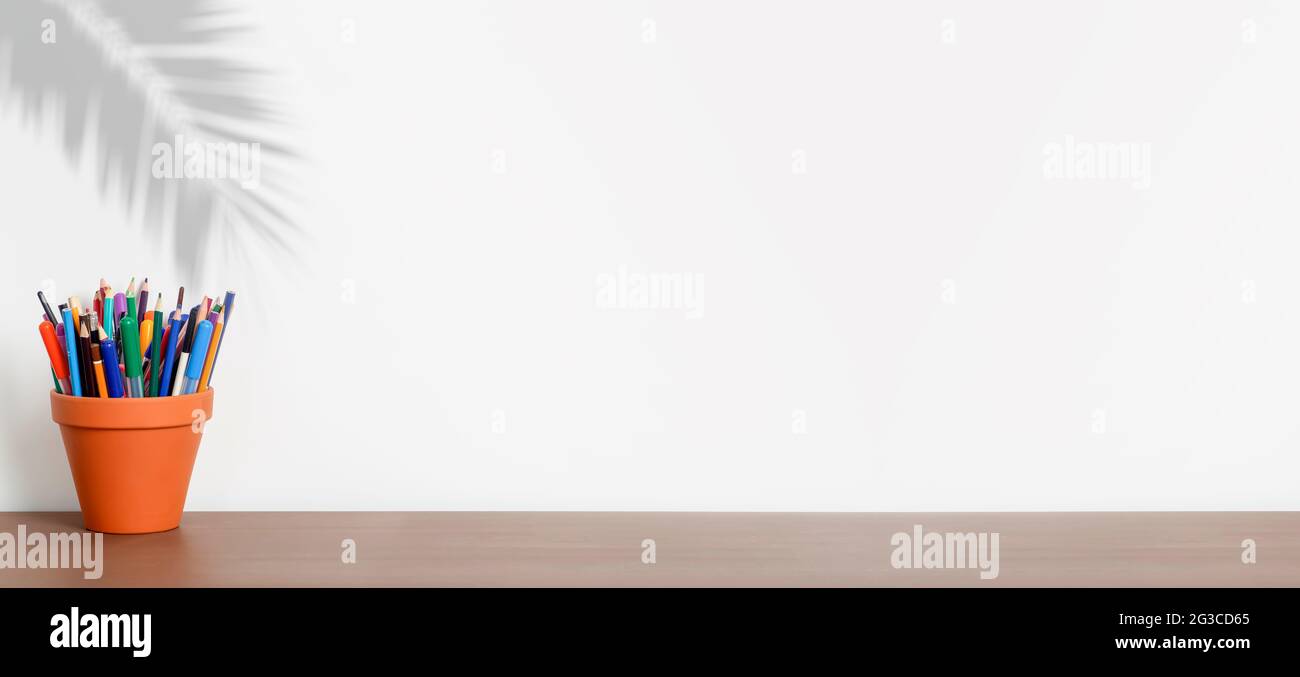 Empty work desk in home office with white wall and pencils and ...