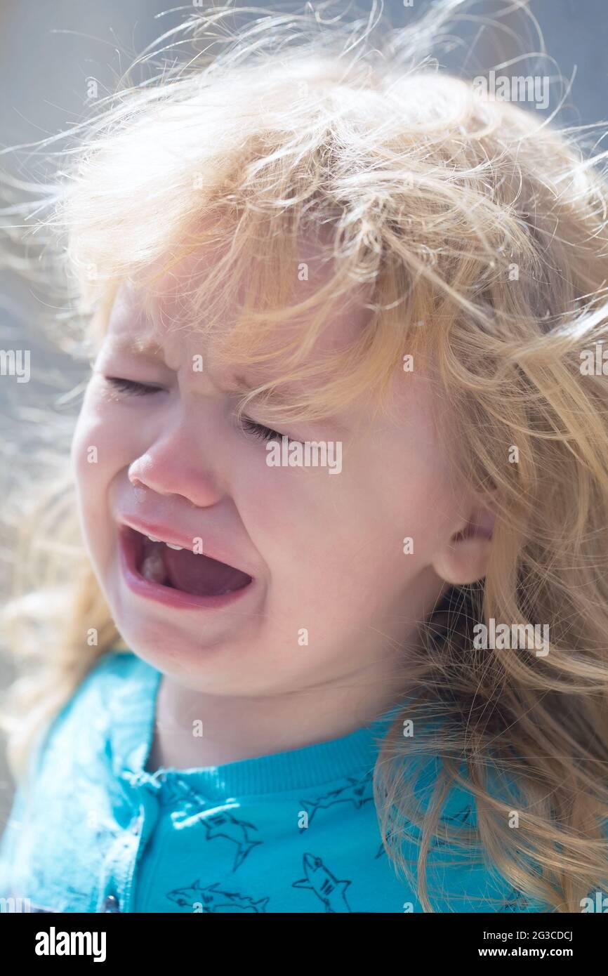 Cute unhappy baby boy crying Stock Photo - Alamy