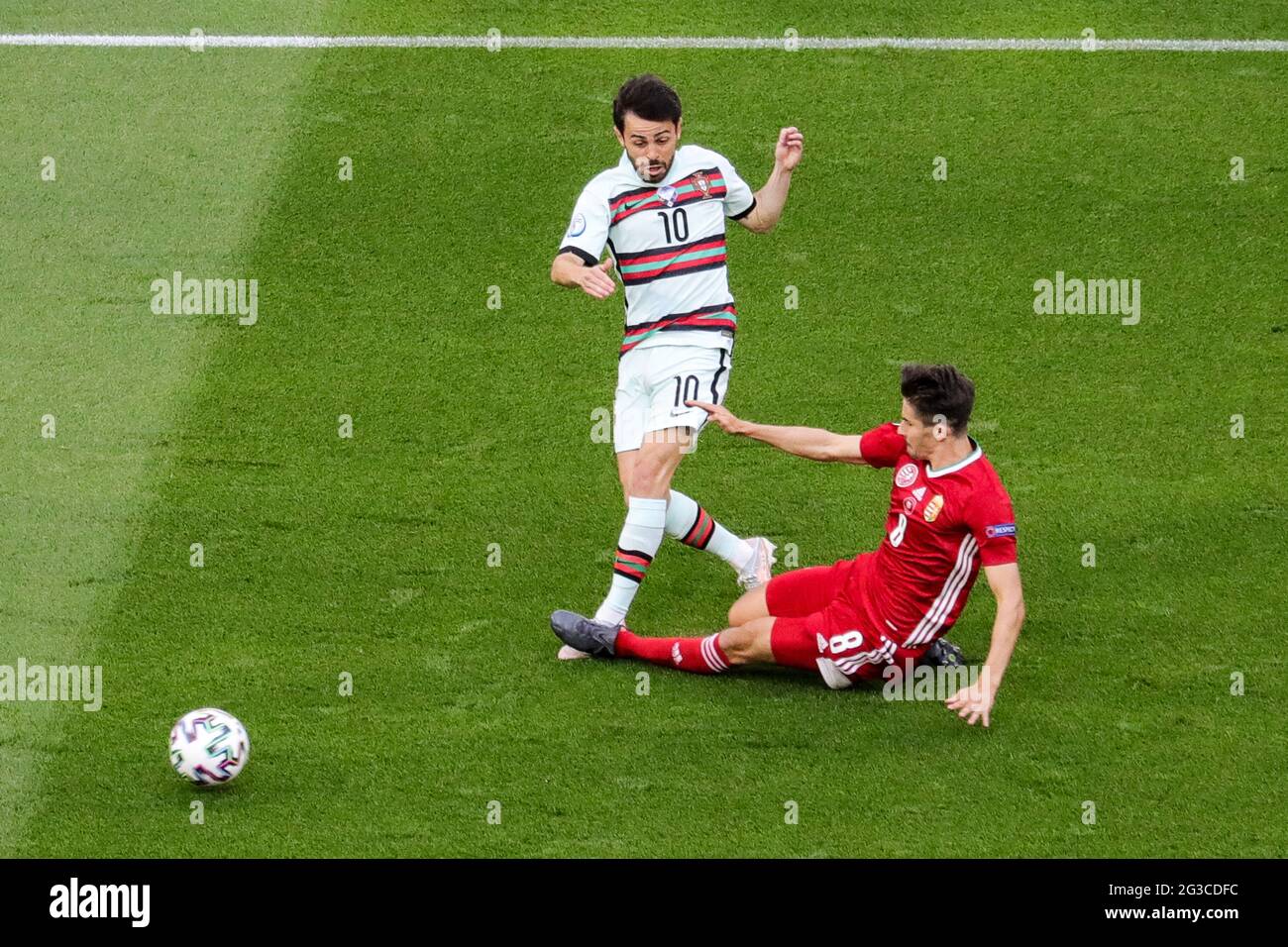Budapest, Hungary. 15th June, 2021. Bernardo Silva gets tackled by Ádám ...