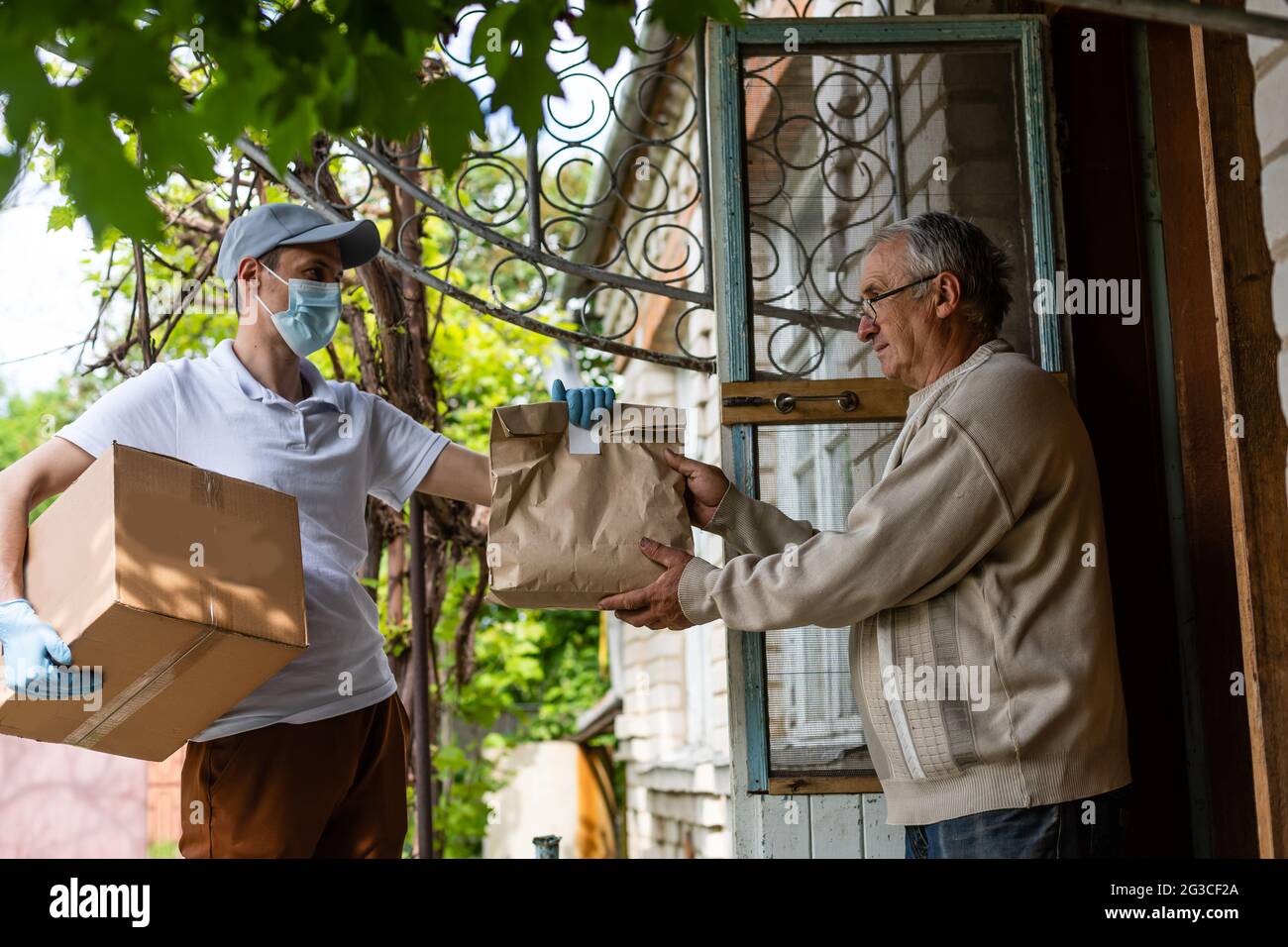 Delivering groceries to elderly person hi-res stock photography and ...