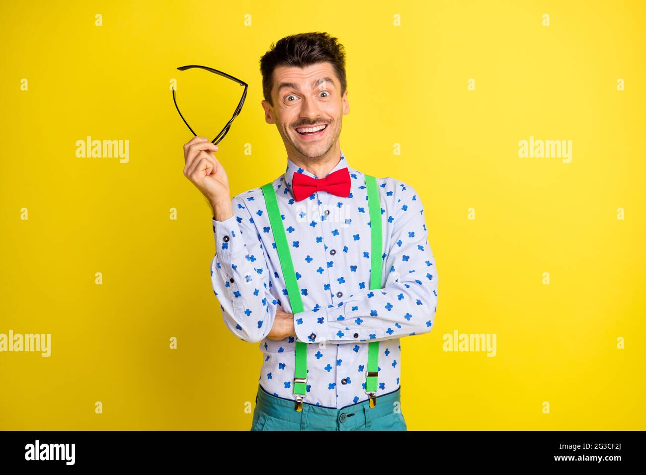 Portrait of attractive cheerful guy showman mc wearing print shirt ...