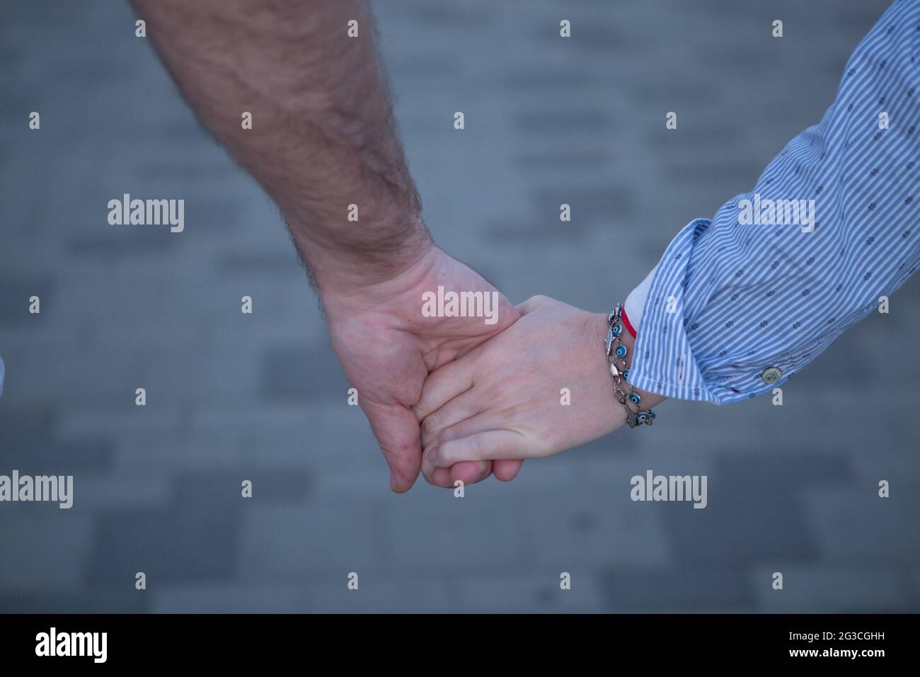 Close-up of a loving couple holding hands while walking. Love and ...