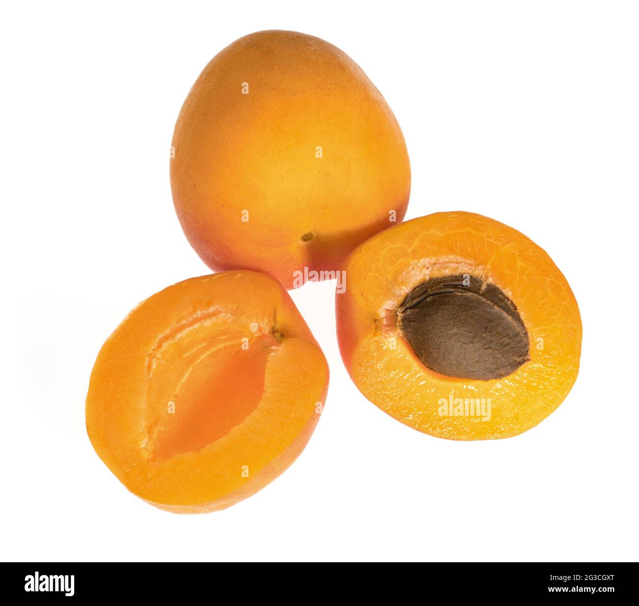 Ripe apricot fruits, one whole and divided into pieces, on a white ...