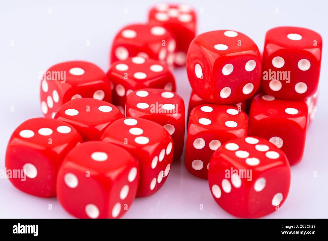 Selective focus shot of several red dices isolated on white background ...