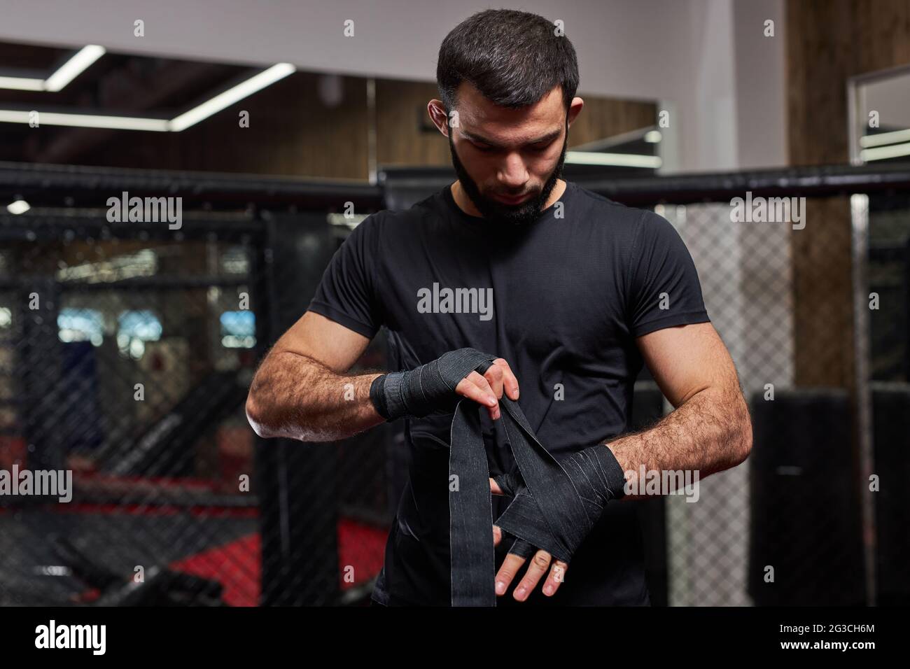 Serious Male Kickboxer Fighter Preparing For Fight, Wrapping Hand In ...