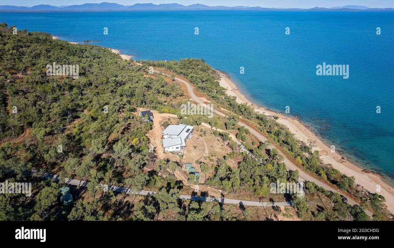 Drone aerial over a coastal bushland environment with homestead and a ...