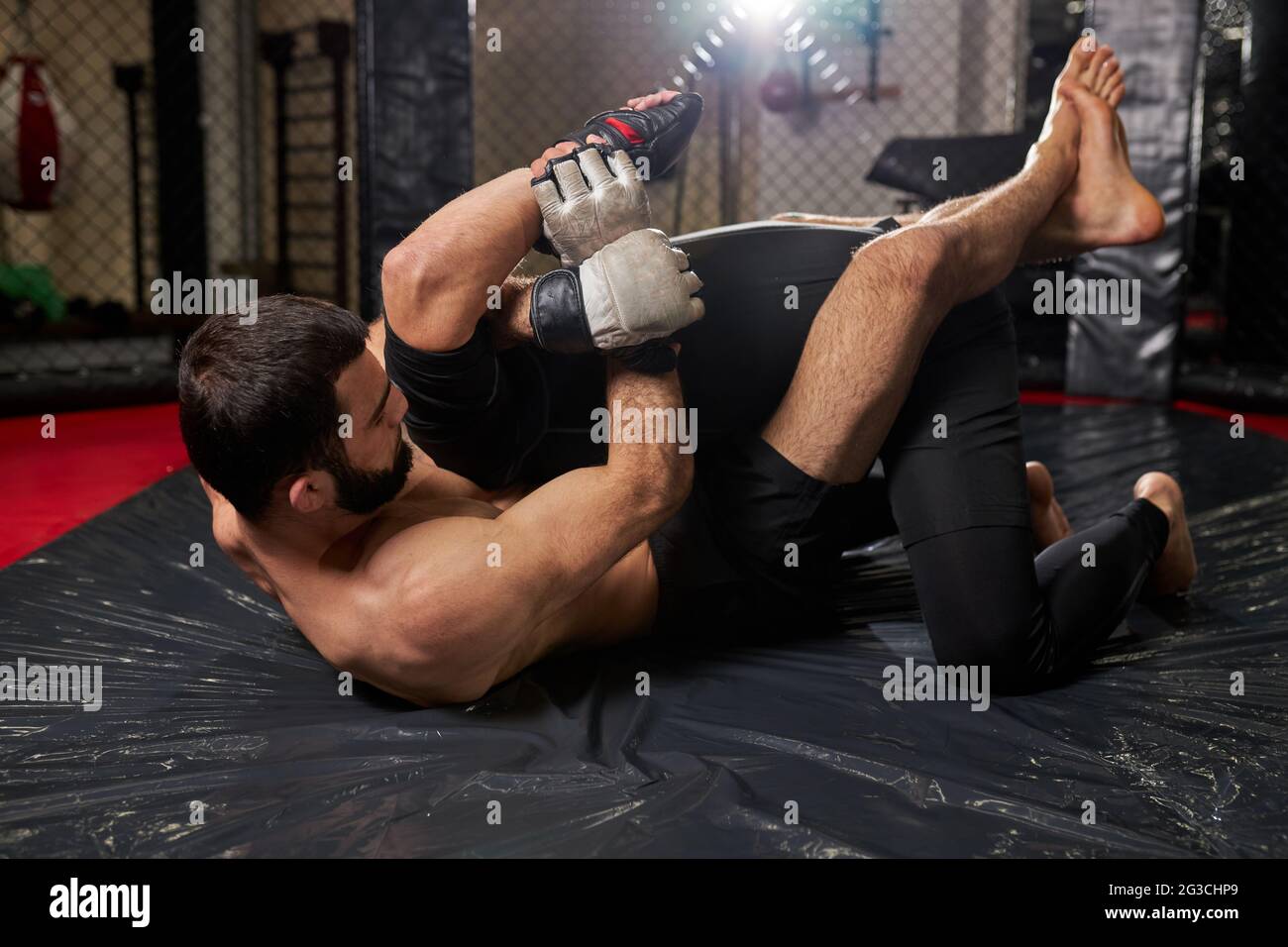 Sports concept of fighting without rules. Two athlete wrestlers at gym ...