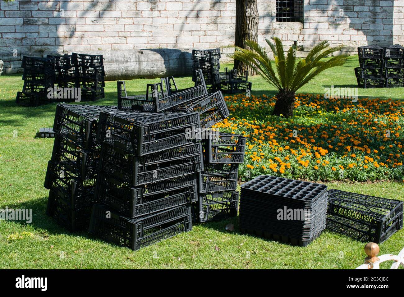 Plastic boxes for gardening in a cozy garden Stock Photo - Alamy