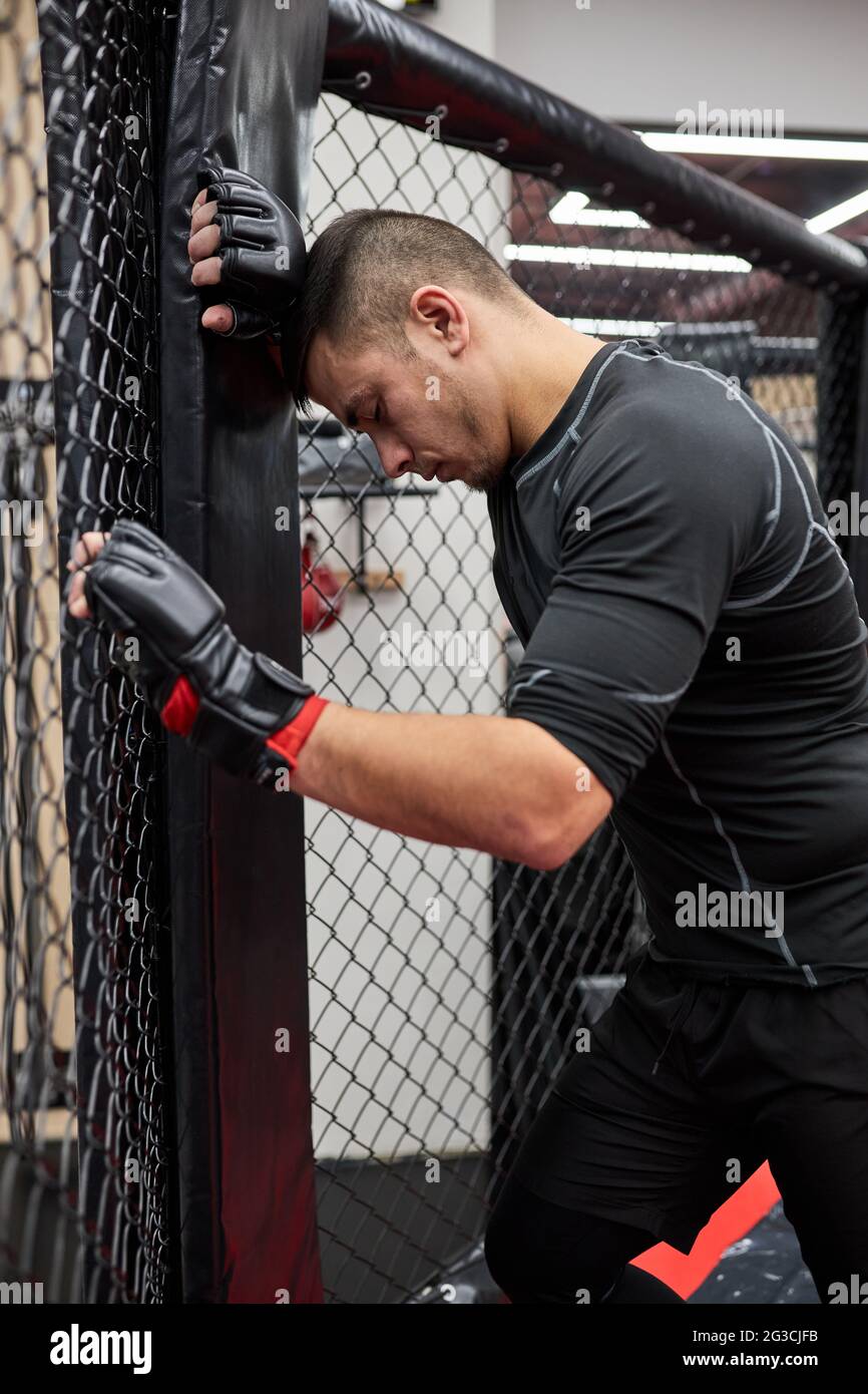 Side view on fitness sporty tired man spend time in gym practicing ...