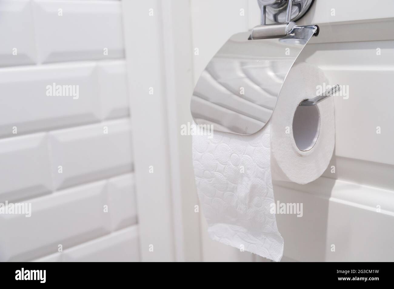 toilet paper roll hanging in bathroom close up Stock Photo - Alamy