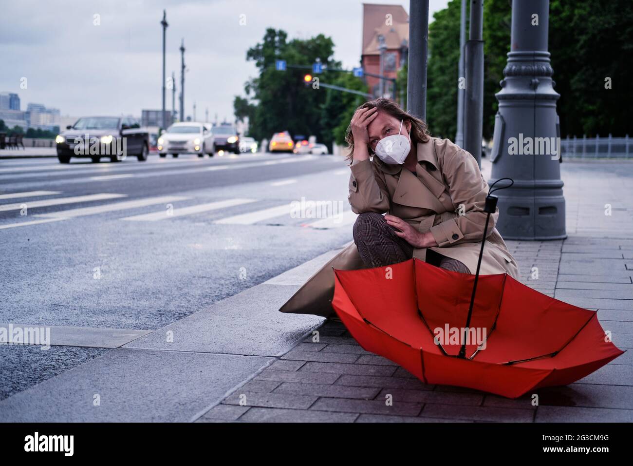 Mature person in mask umbrella hi-res stock photography and images - Alamy