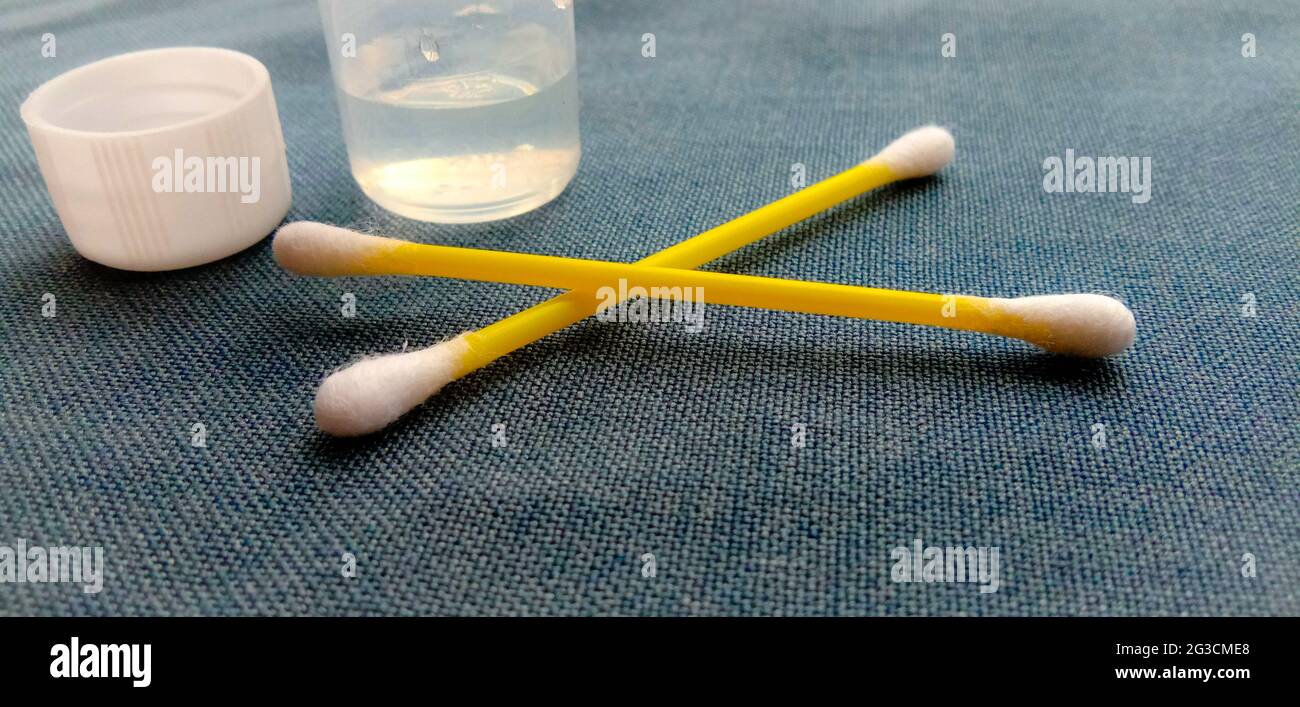 Closeup shot of some sanitary Q-tips and a bottle of rubbing alcohol ...
