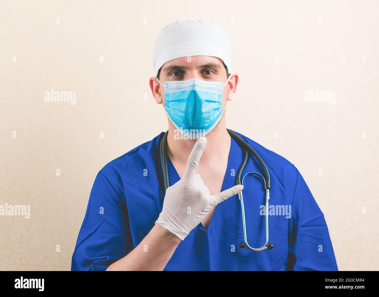 Young doctor portrait in blue surgeon suit and protective breathing ...