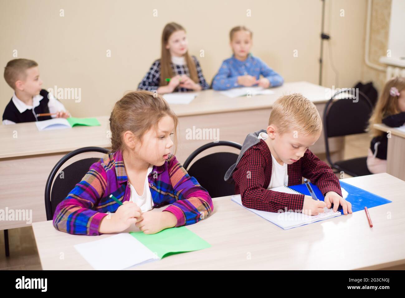 Group of elementary pupils in the classroom Stock Photo - Alamy