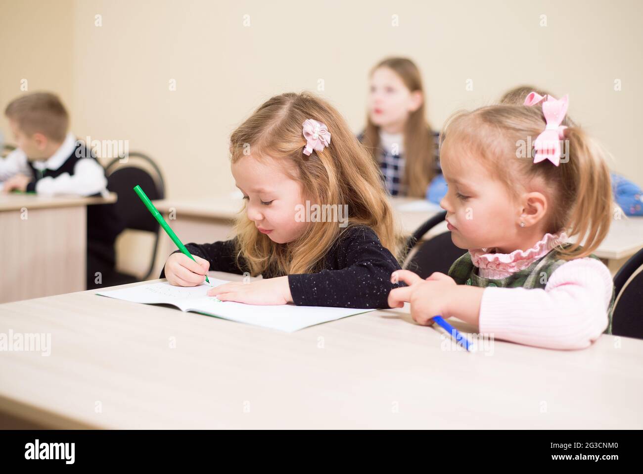 Group of elementary pupils in the classroom Stock Photo - Alamy