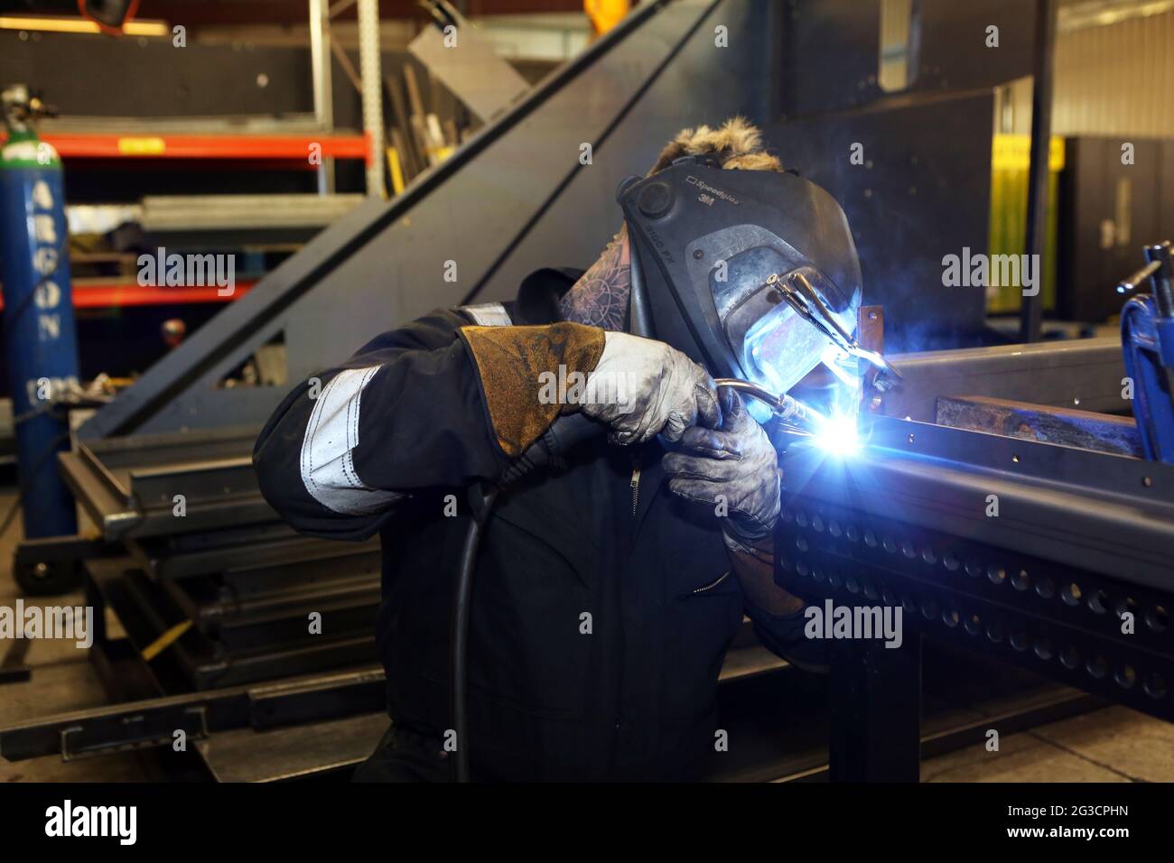 A welder working at Universal Wolf, (a local manufacturing business ...