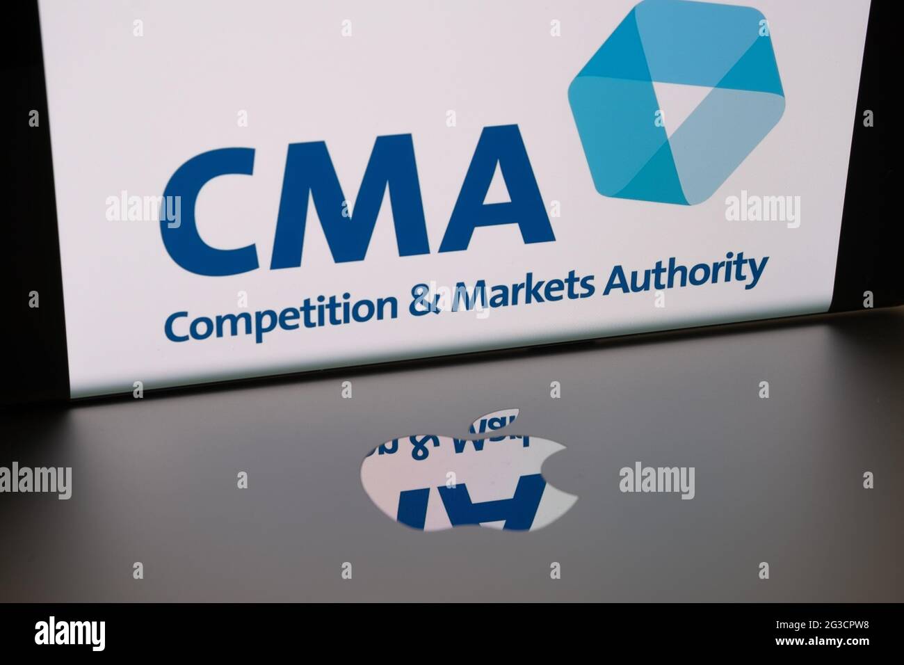 Apple logo on macbook surface and blurred UK CMA Competition and ...