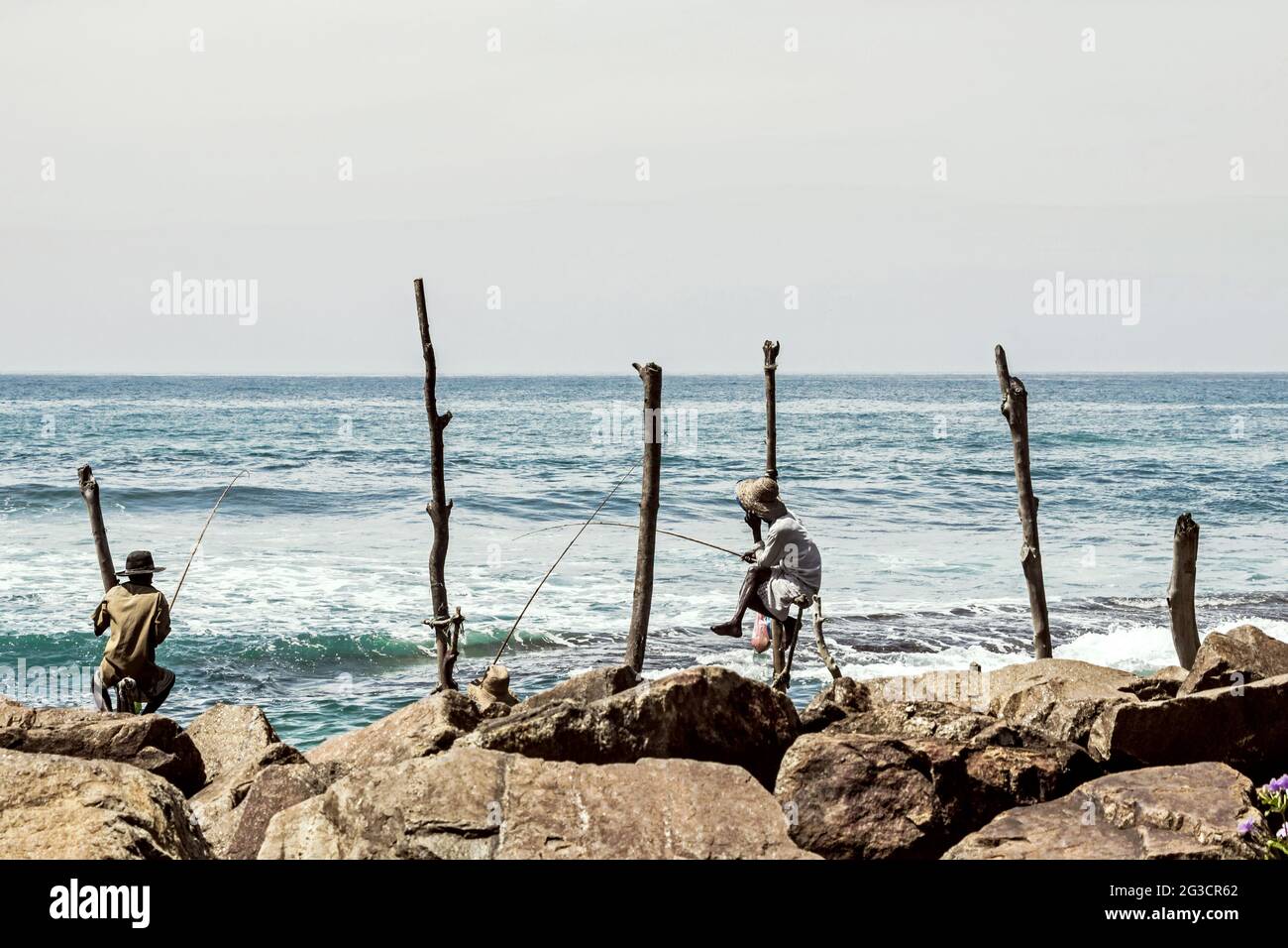 Stick fishing man in ocean at Weligama beach in Sri Lanka Stock Photo ...