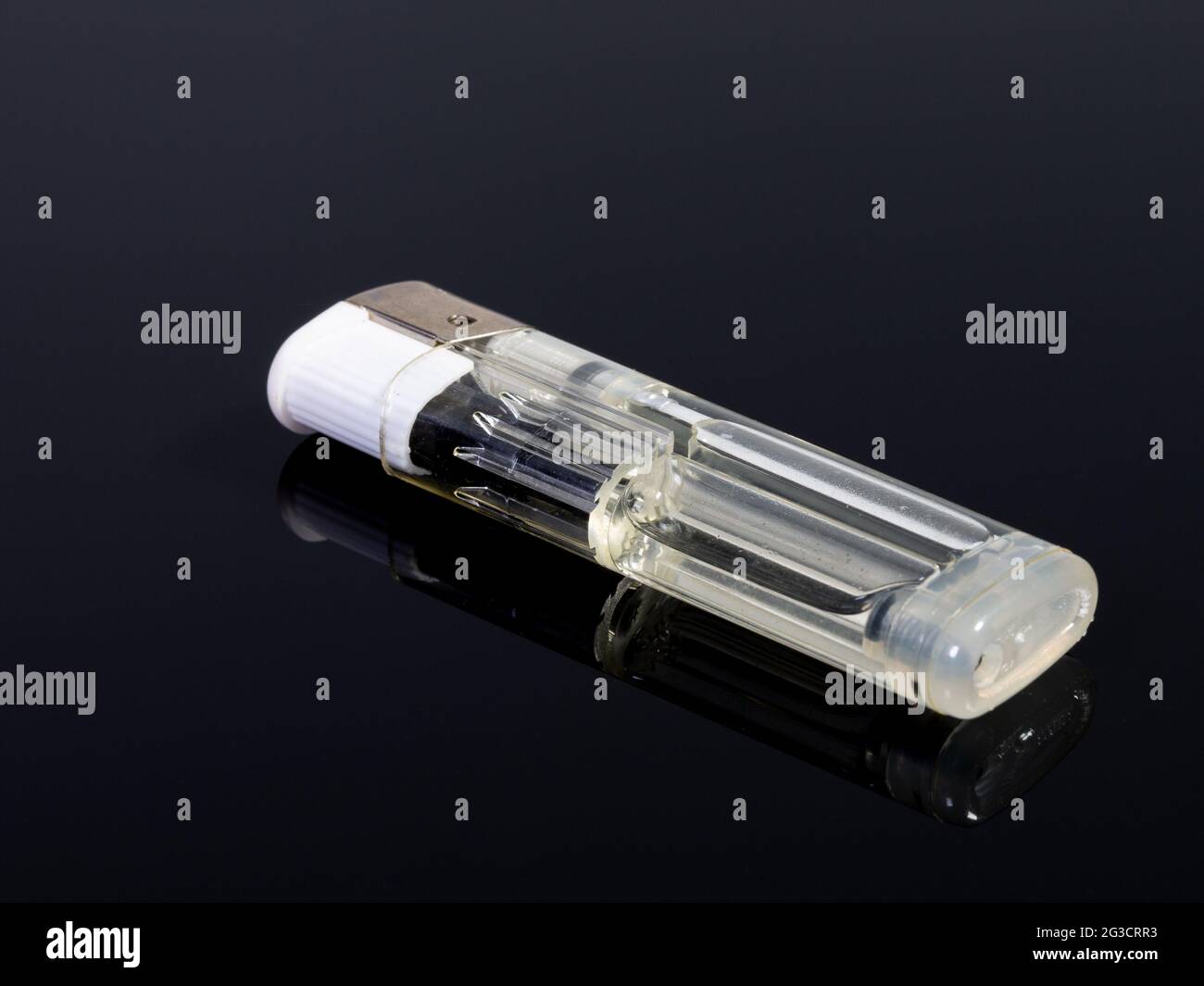 White gas lighter on a black reflecting background Stock Photo - Alamy