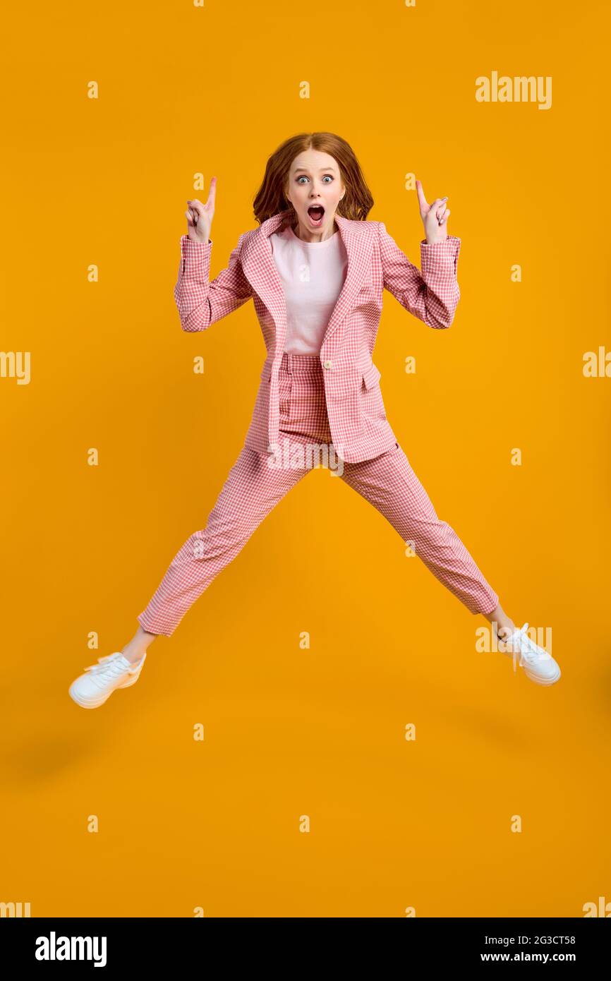 Full length photo of funny caucasian lady in pink suit jumping up high ...