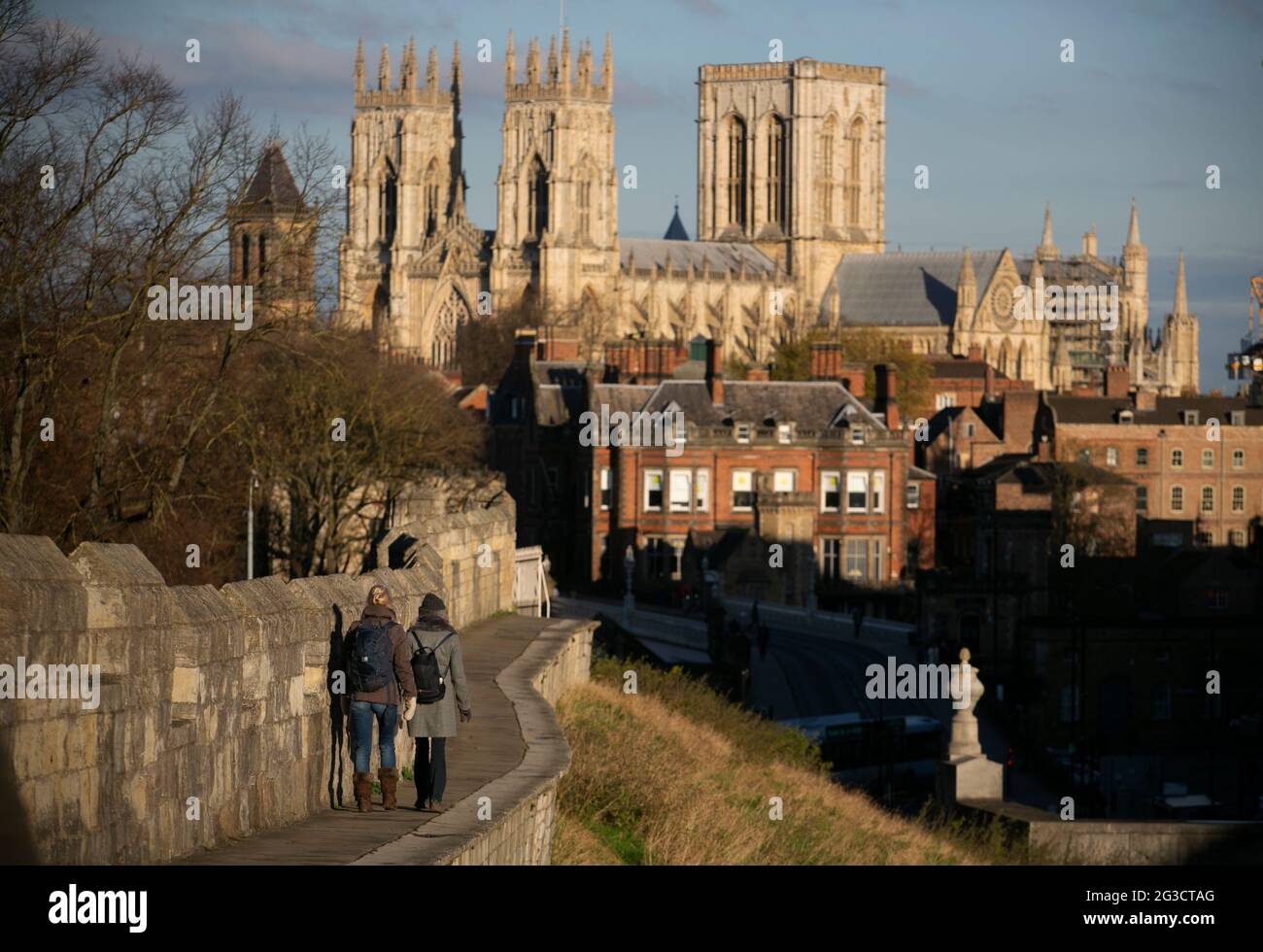 People walk along the ancient roman city walls of York with York ...