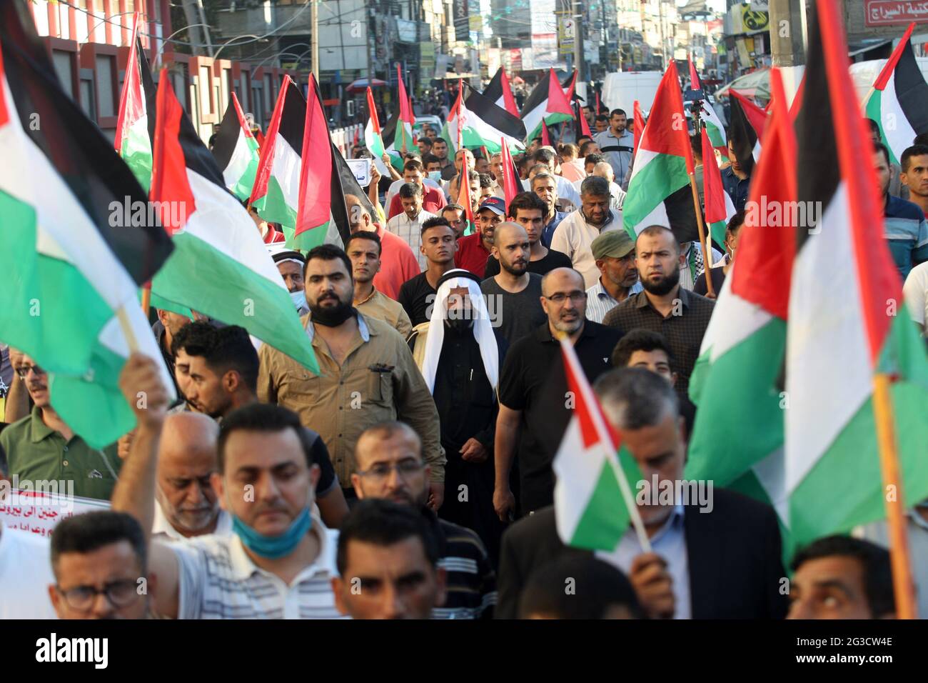 Rafah, Gaza. 15th June, 2021. Palestinians lift national flags during a ...