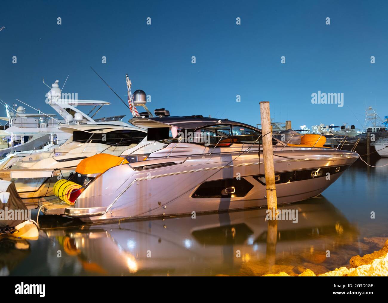 Voyage is waiting. Luxury yacht in Miami, USA. Yacht berth at dusk. Sea ...