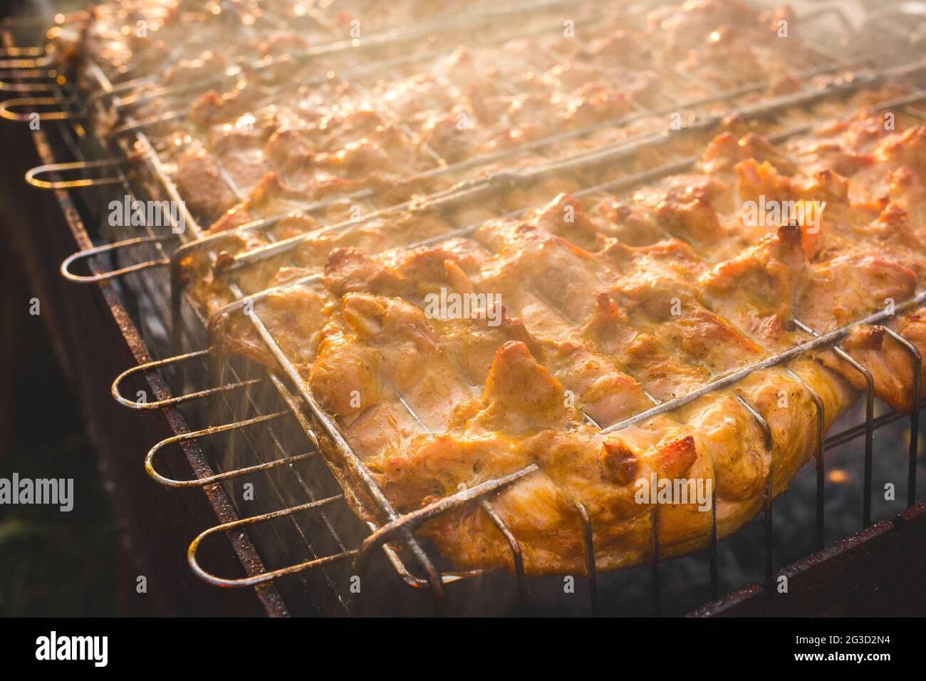 Cooking barbecue chicken meat food on the grill with smoke, outdoor ...