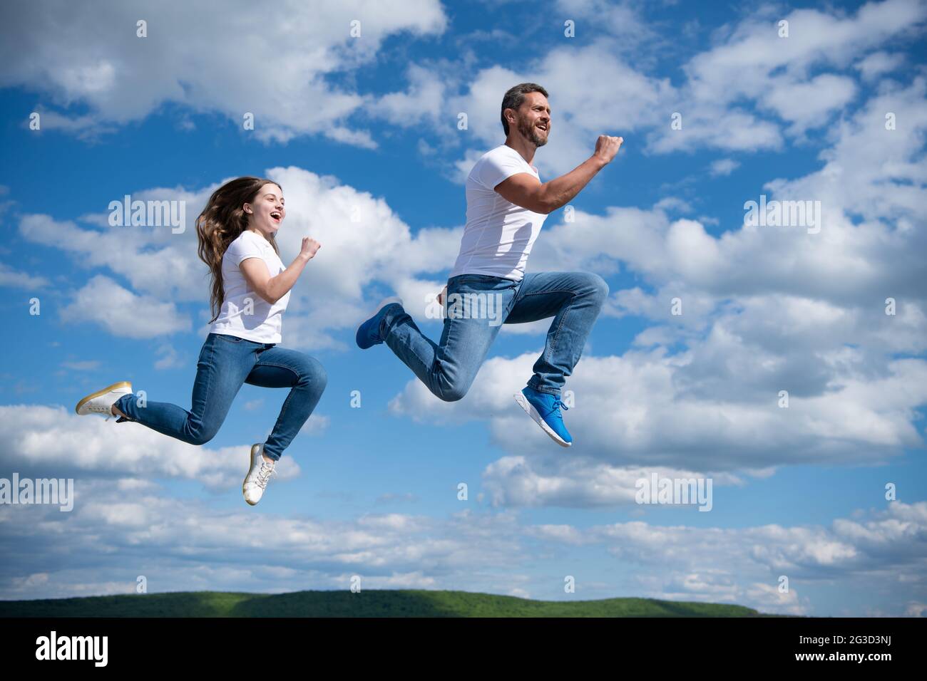 father and daughter jump high. hurry up. happy childhood and fatherhood ...