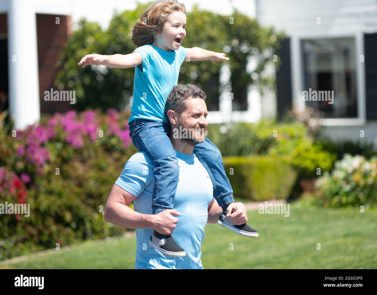 Boy sitting on fathers shoulders hi-res stock photography and images ...