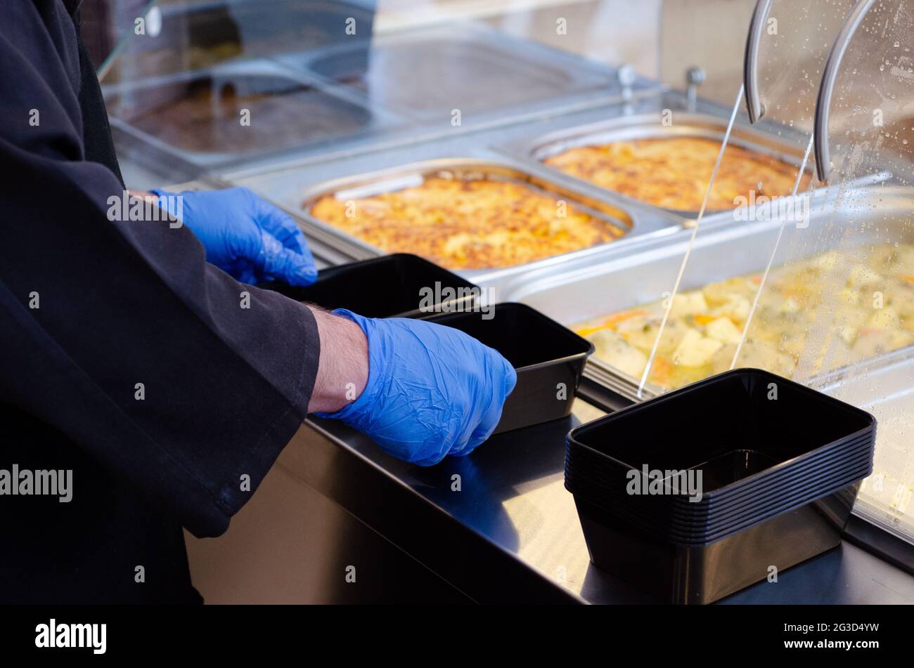 Chef preparing empty plastic containers to serve food Stock Photo - Alamy