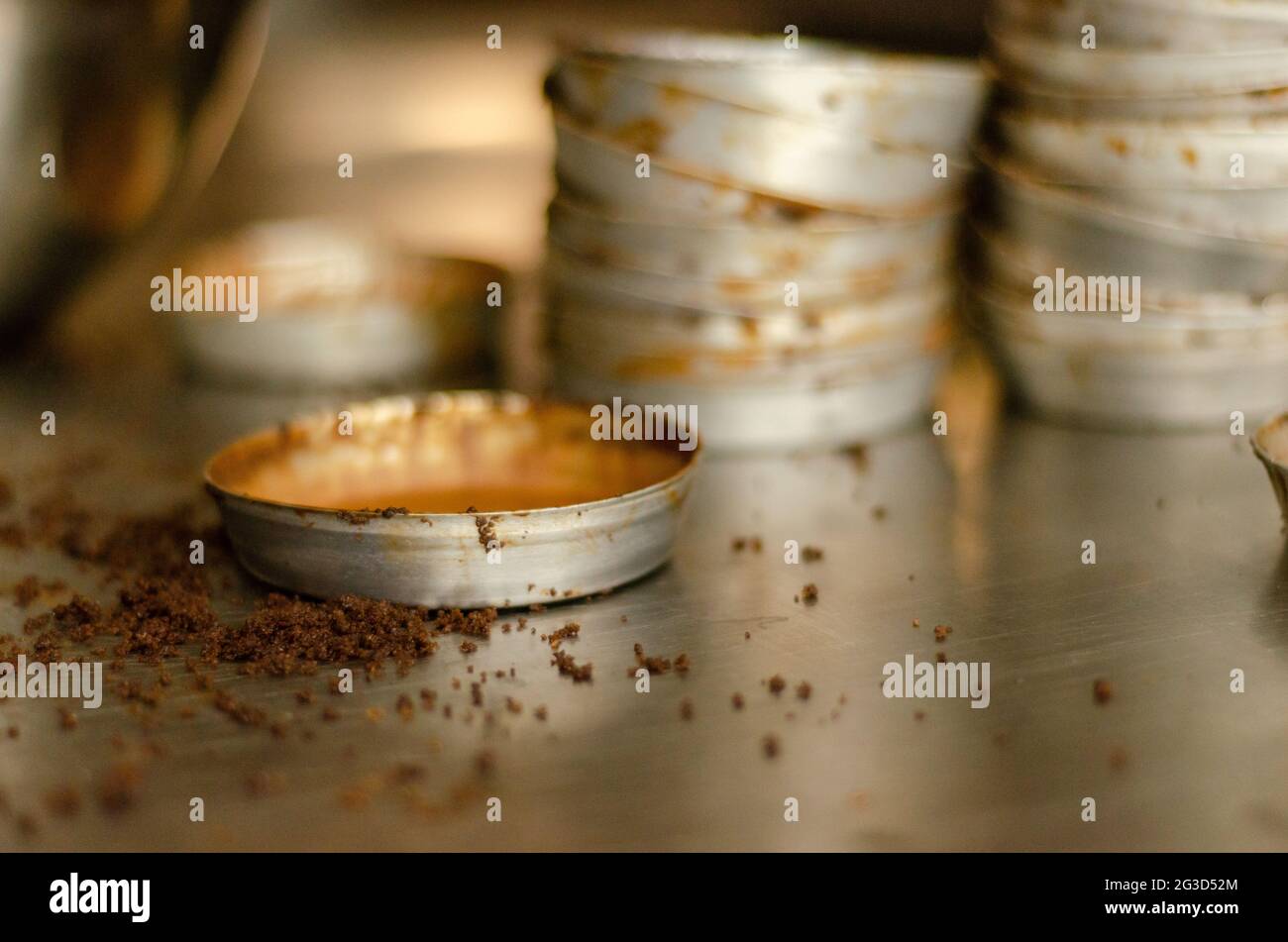 Metal cupcake forms on the kitchen table Stock Photo - Alamy