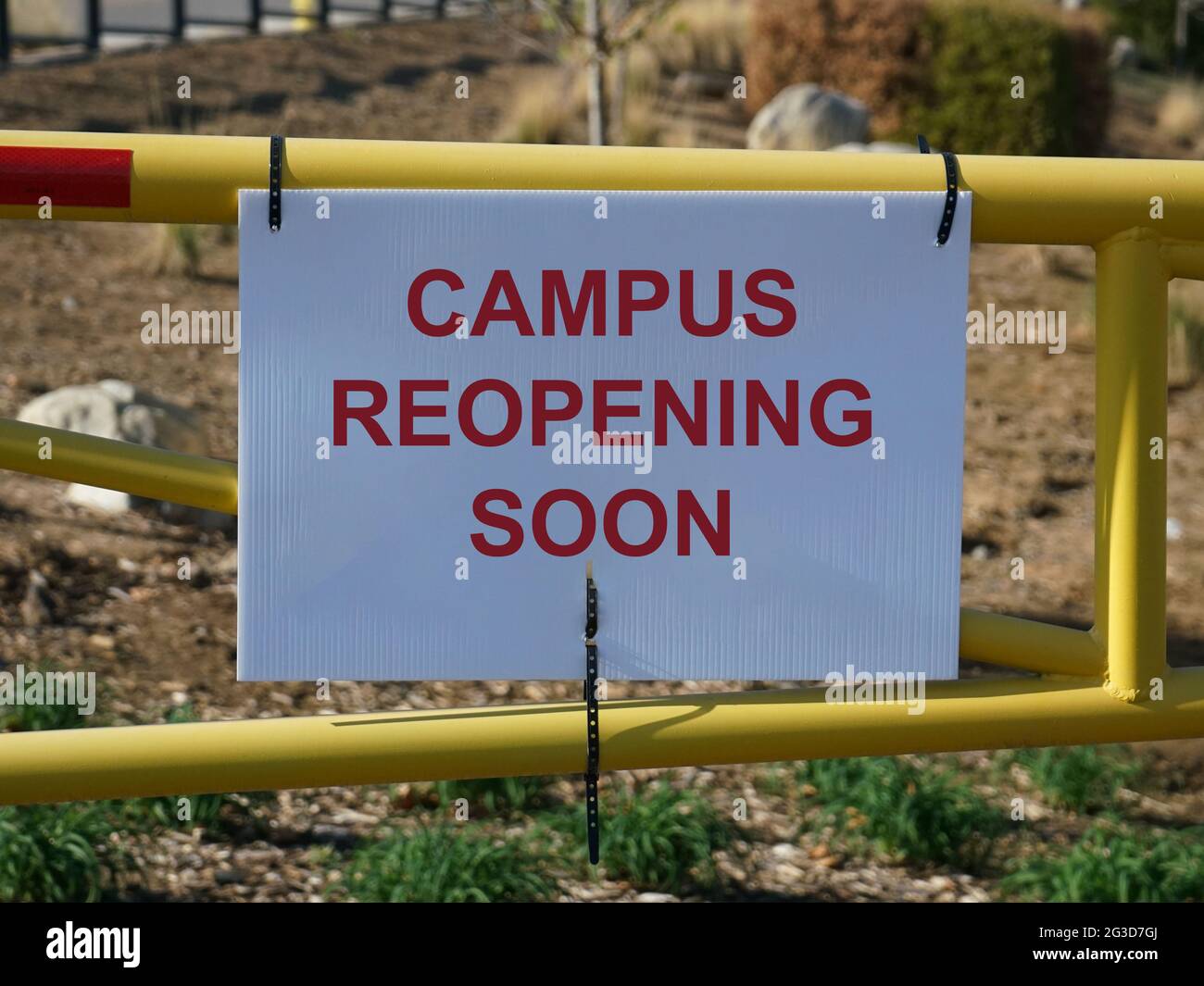 Sign on gate stating school campus will be reopening soon COVID-19 ...