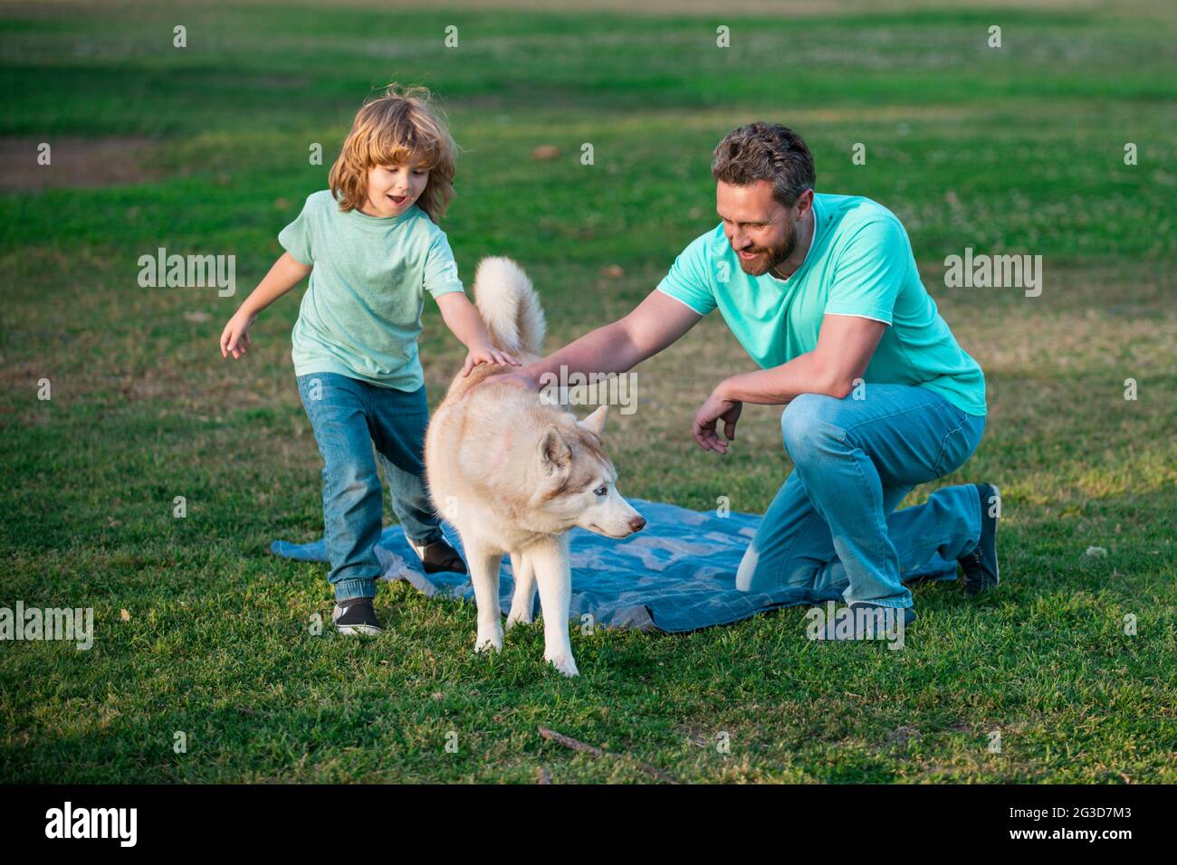 Father and son walking with dog on nature, outdoors. Happy family. Dad ...