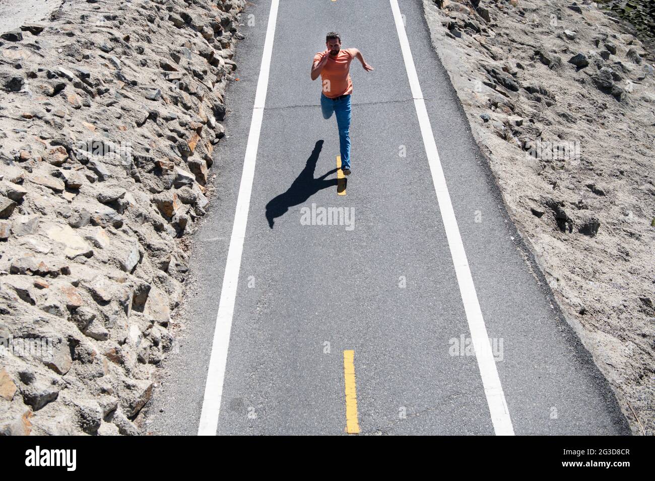 Man running on the road. Sporty man runner running in summer Stock ...
