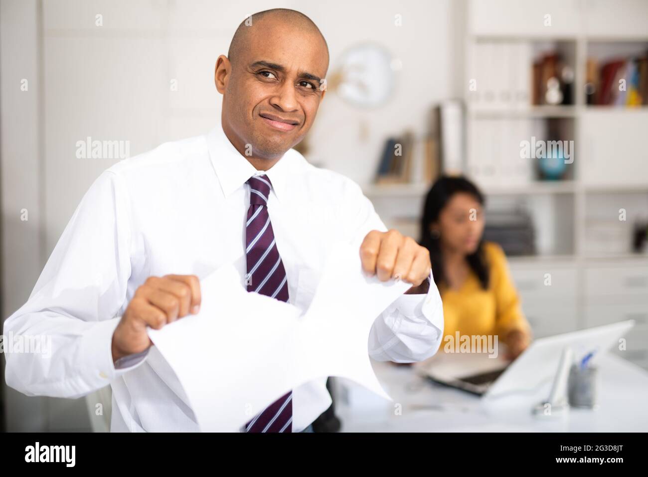 Angry businessman tearing up paper after quarrel Stock Photo - Alamy