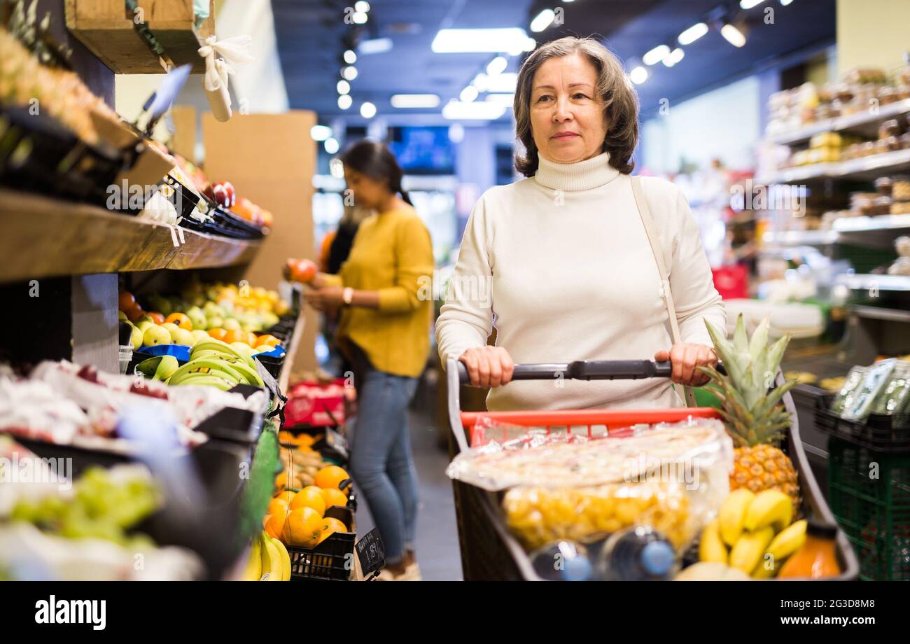 Casual woman doing shopping in grocery department of supermarket Stock ...