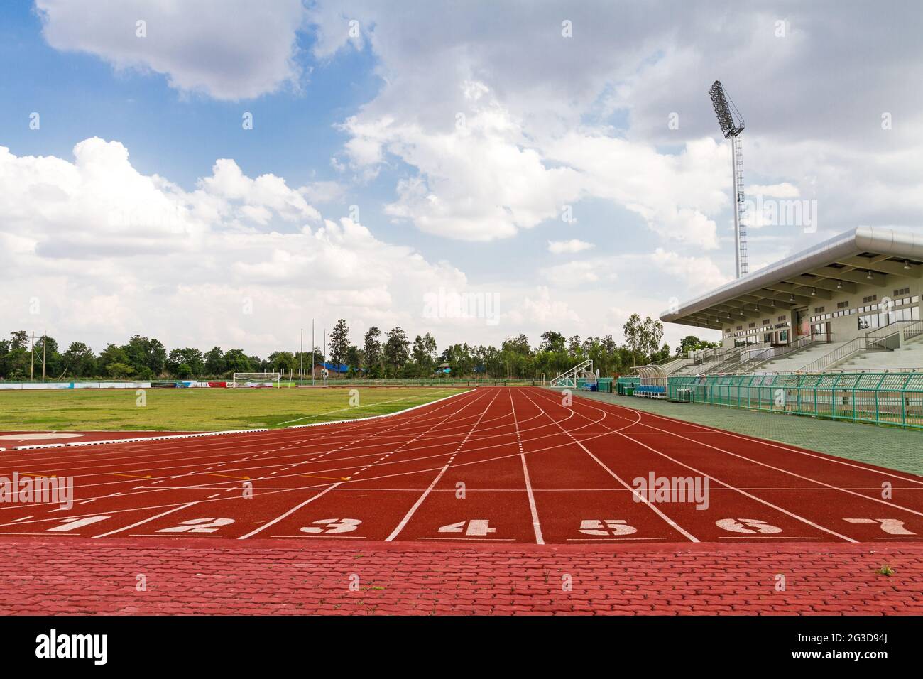 Red running track and blue sky Stock Photo - Alamy