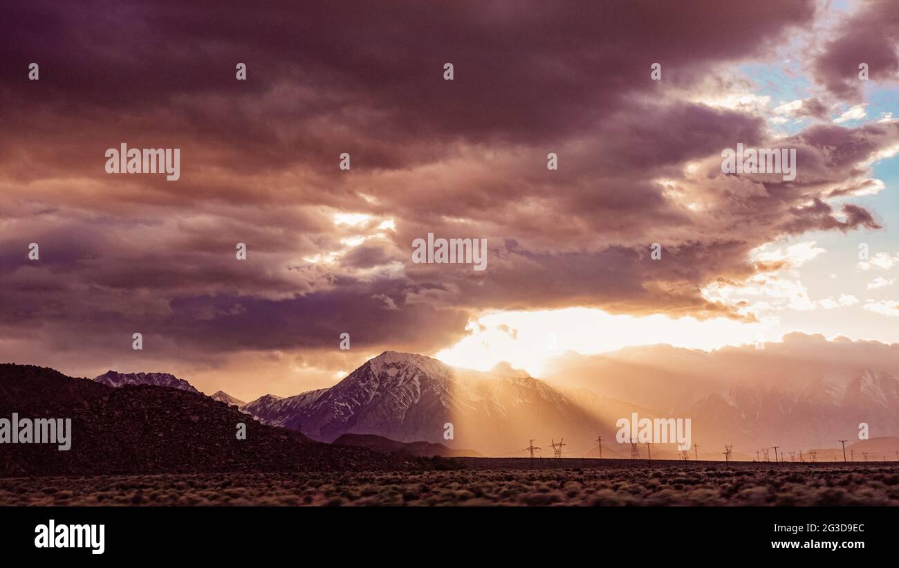 Dramatic sunset in Sierra Nevada's rays of light and clouds Stock Photo ...