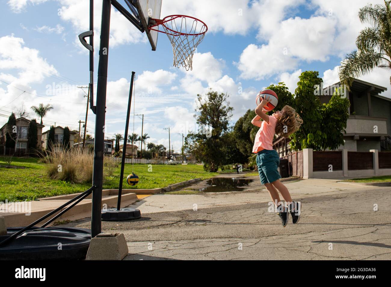 Cute little boy child jumping with basket ball for shot. Kid playing ...