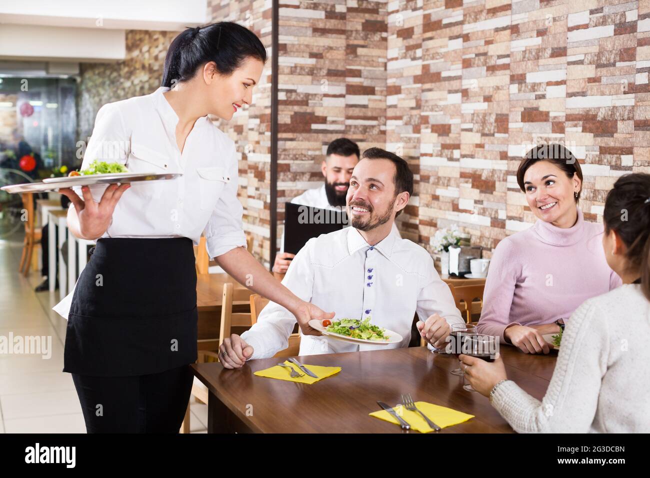 Waitress taking table order at tavern Stock Photo - Alamy
