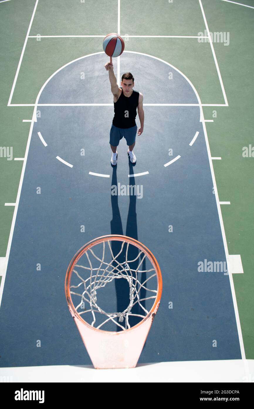 Basketball player shooting ball in hoop outdoor court. Urban youth game ...