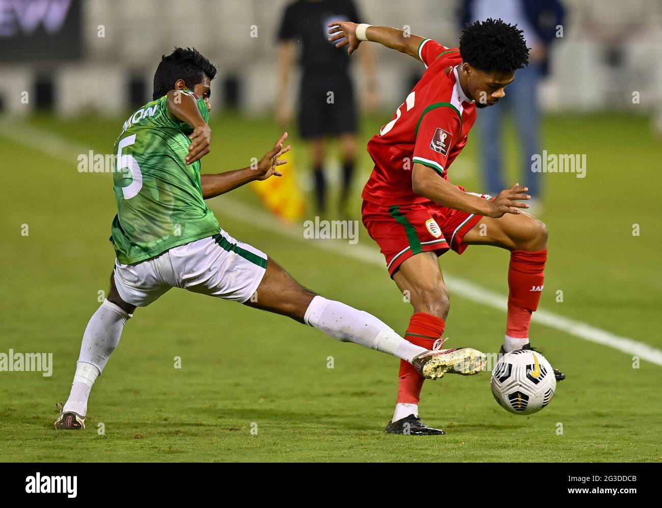 Doha, Qatar. 15th June, 2021. Jameel Al Yahmadi (R) of Oman vies with ...